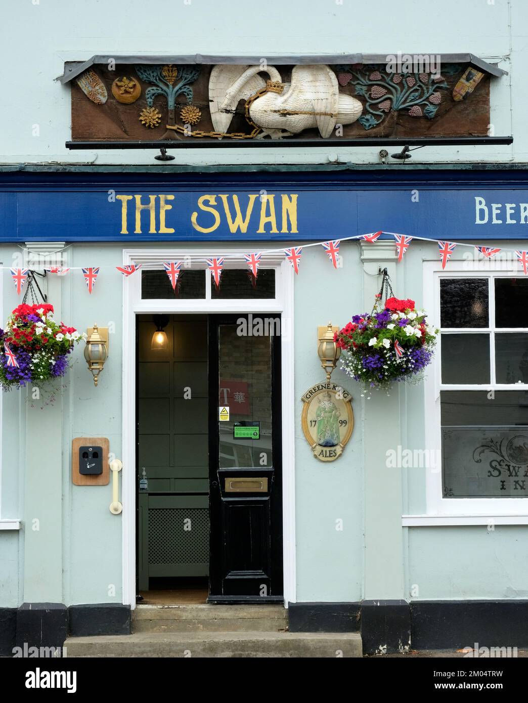View of The Swan Inn and England's Oldest Pub sign in the village of ...