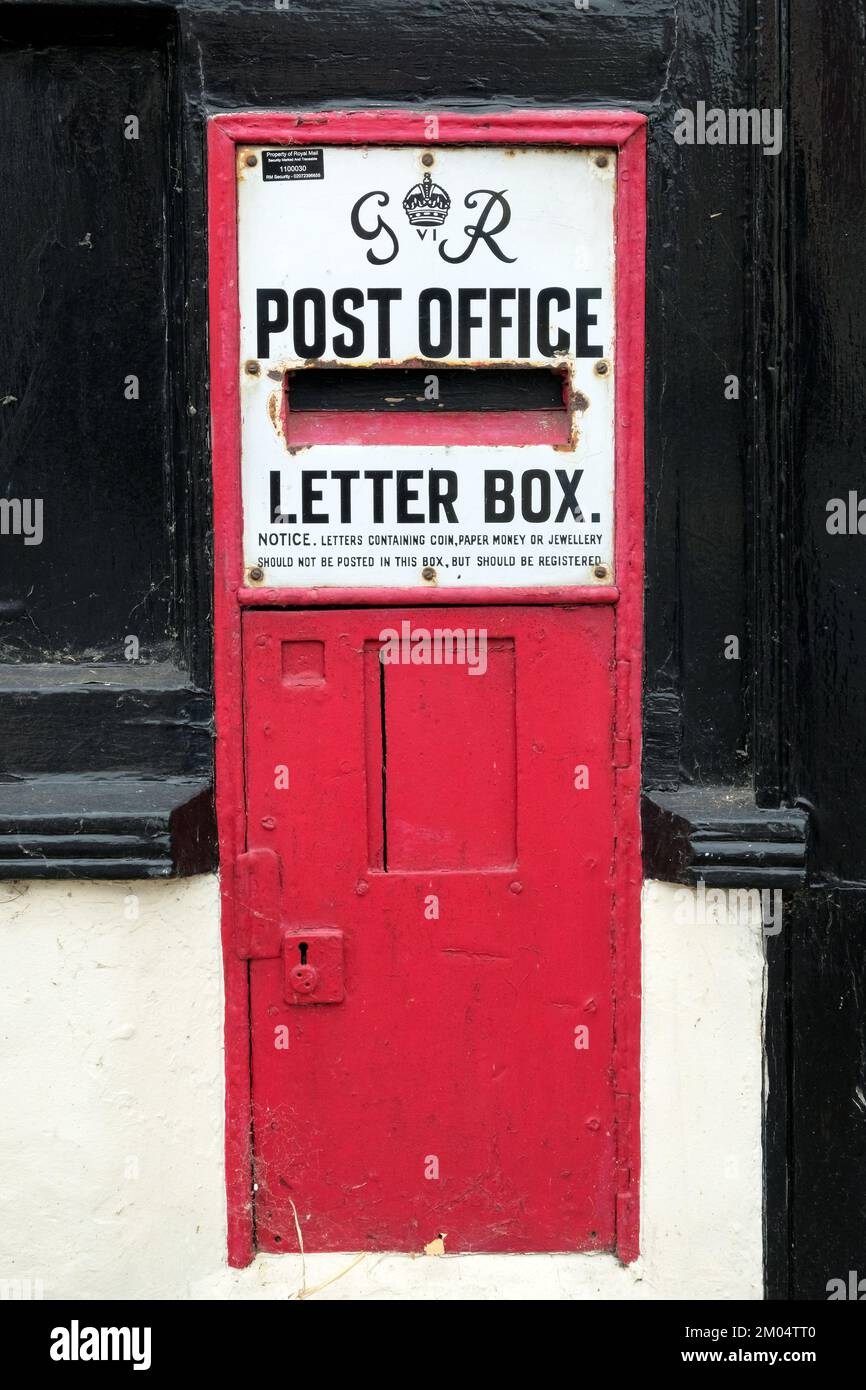 Portrait view of Old King George V letter box in wall Clare Suffolk ...