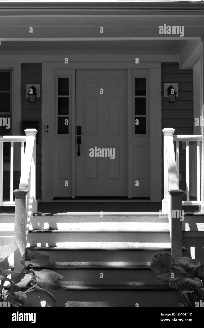 Typical wooden stairs leading up to a colonial home in a black and ...