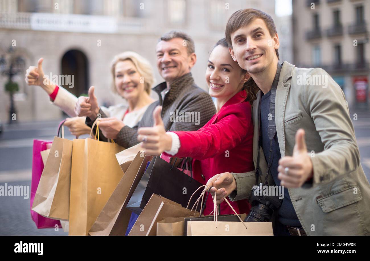parents with older children rejoice with many shopping packages after ...