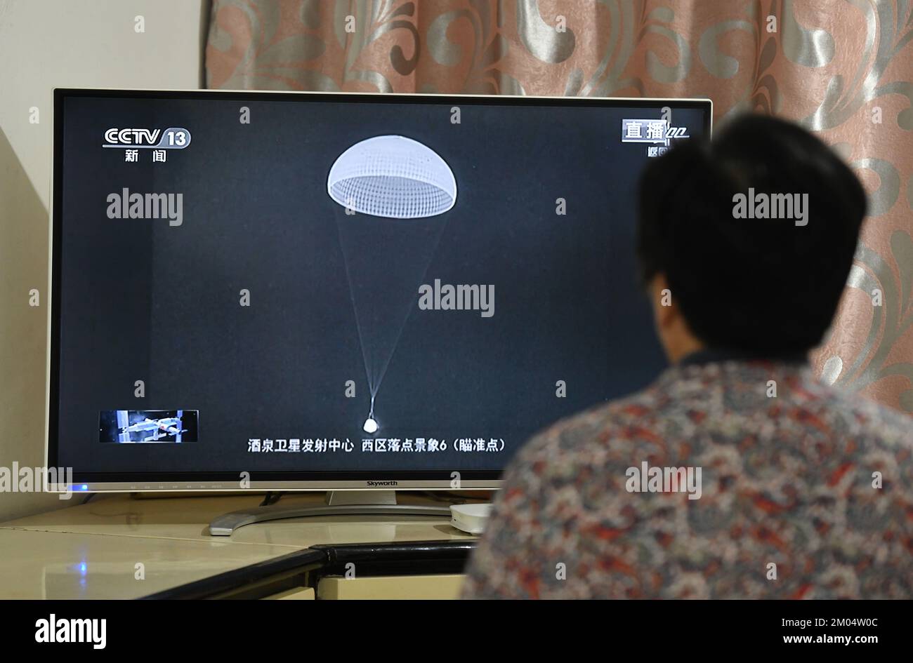 FUYANG, CHINA - DECEMBER 4, 2022 - Citizens watch a live TV broadcast ...