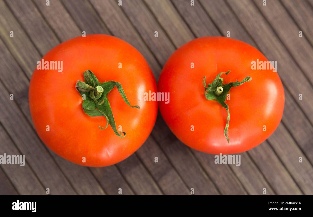 ripe appetizing rispentomatoes tomatoes on wooden table Stock Photo - Alamy