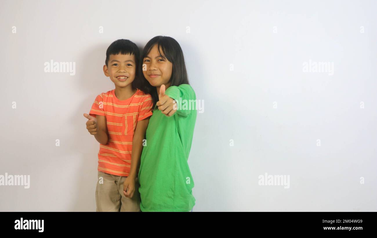 cute brothers and sisters isolated white background Stock Photo - Alamy