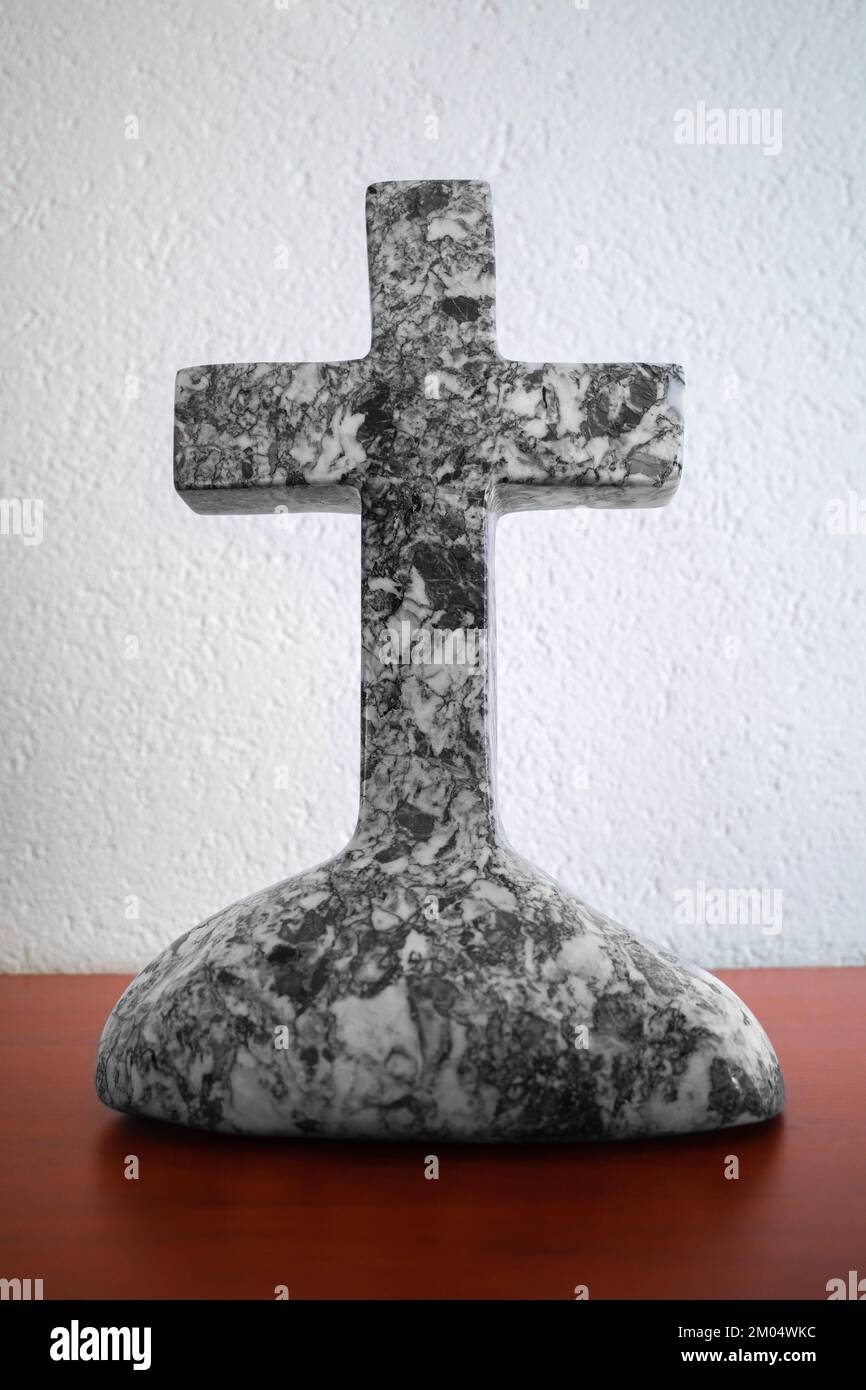 A stone gray Christian cross made from one stone Stock Photo - Alamy