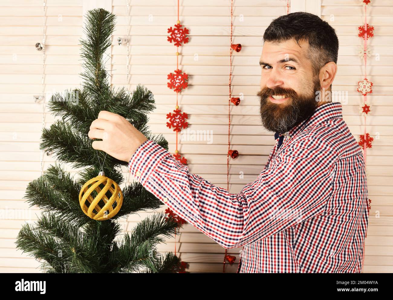 Guy decorates Christmas tree. Santa Claus in modern style Stock Photo ...