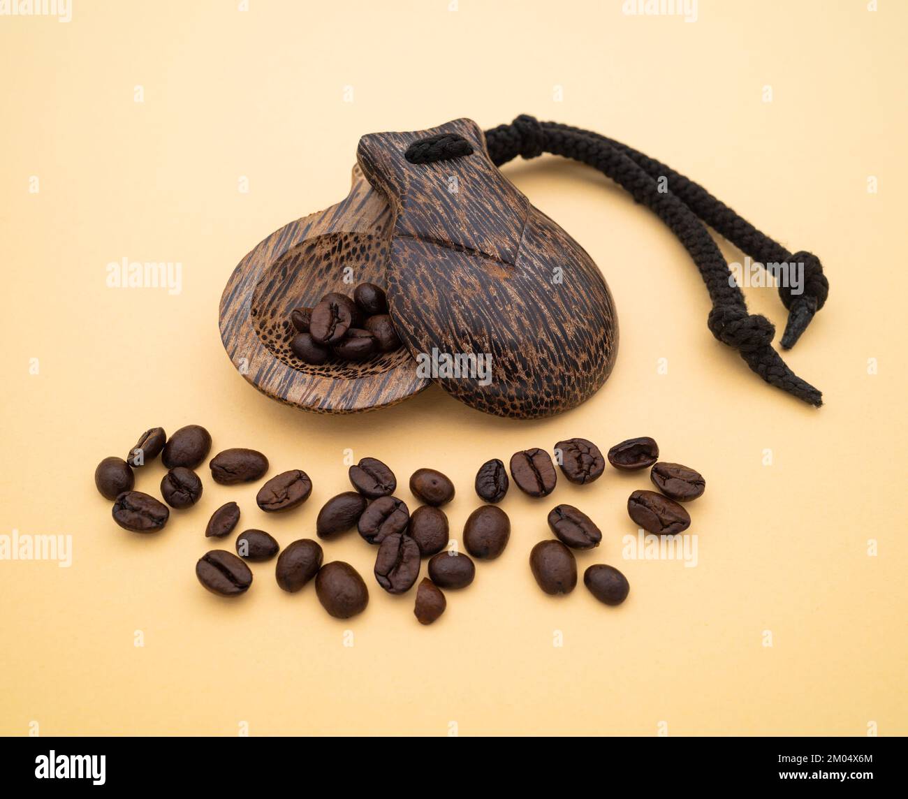 Percussive instrument castanets on the creamy background with coffee ...