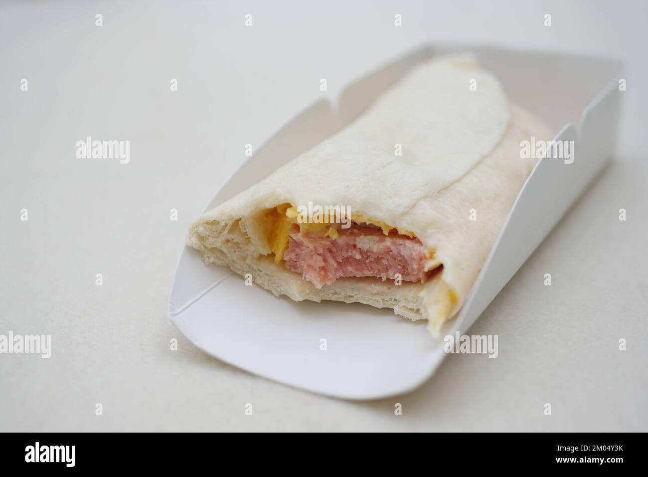 half eaten chicken warp in a paper packet on table Stock Photo - Alamy