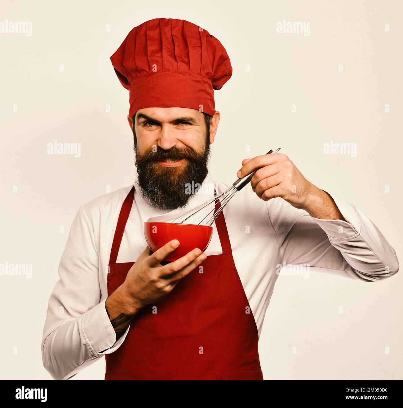 Man with beard holds kitchenware on white background Stock Photo - Alamy
