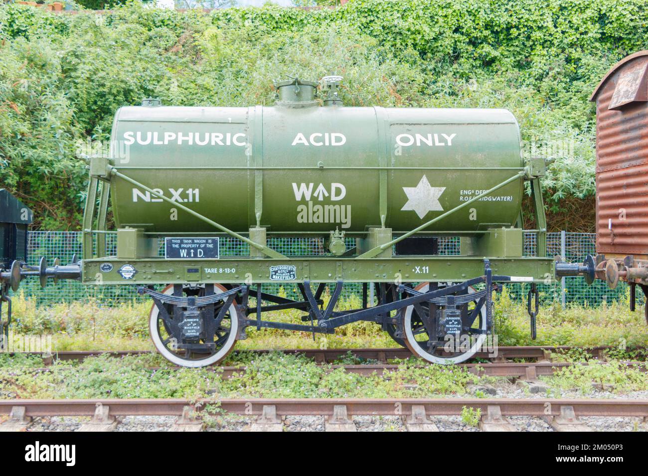 vintage railway freight wagon and sulphuric acid tanker on rail line at ...