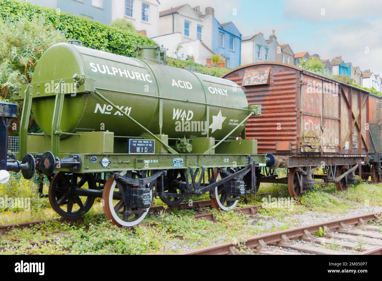 vintage railway freight wagon and sulphuric acid tanker on rail line at ...
