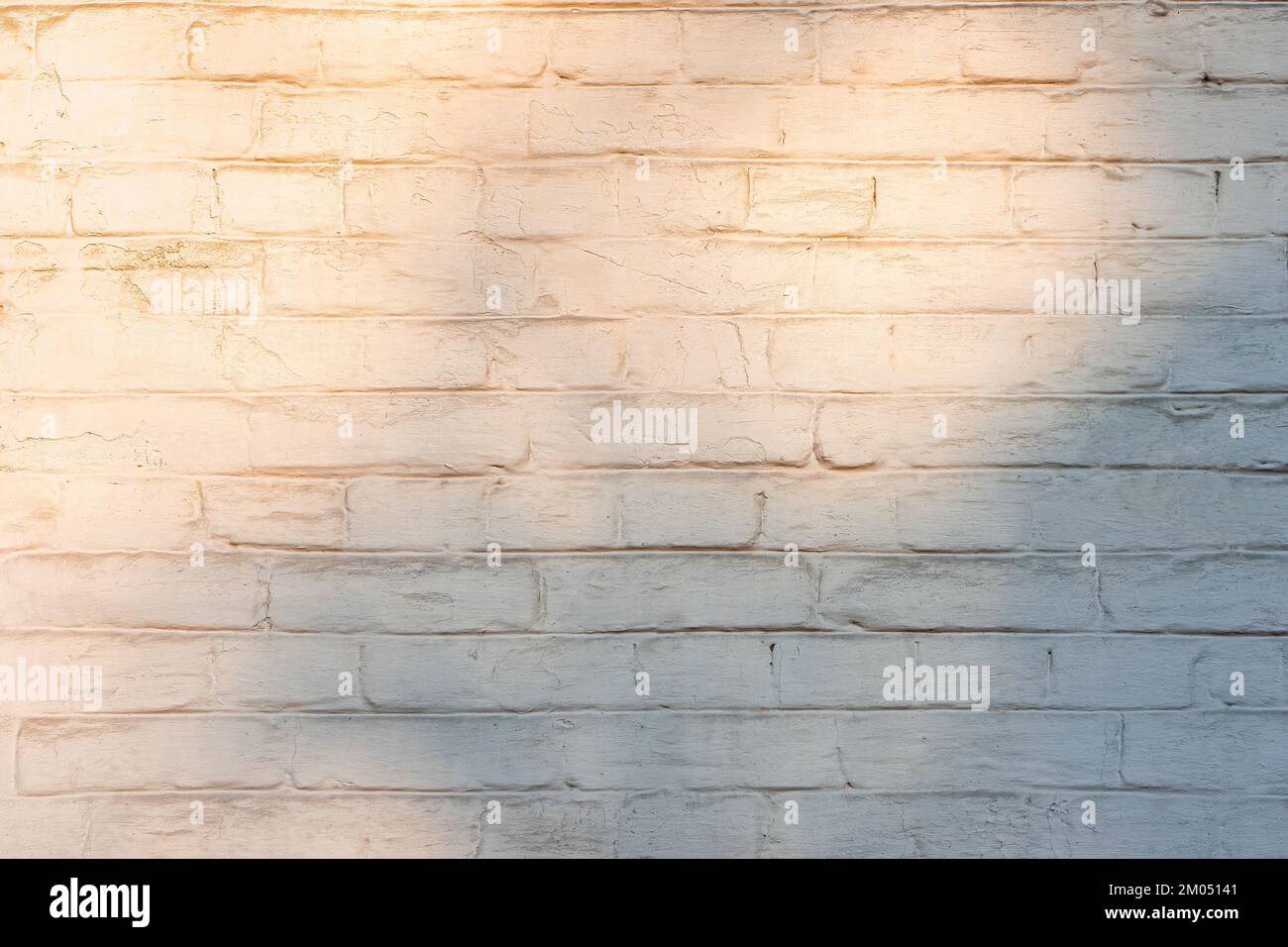White brick wall background with abstract shadow from the sunset light ...