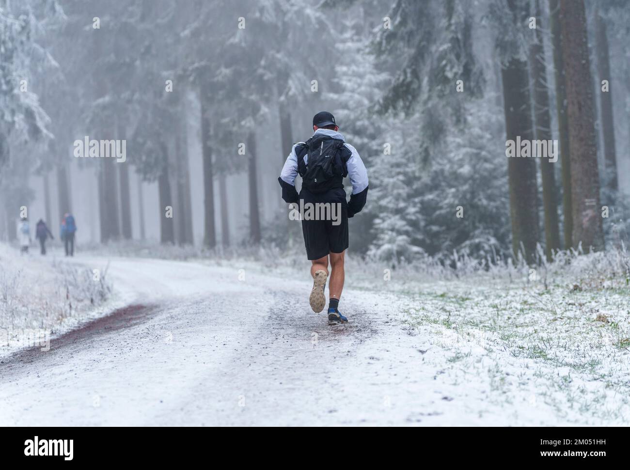 Schmitten, Germany. 04th Dec, 2022. A trail runner runs in shorts on a ...