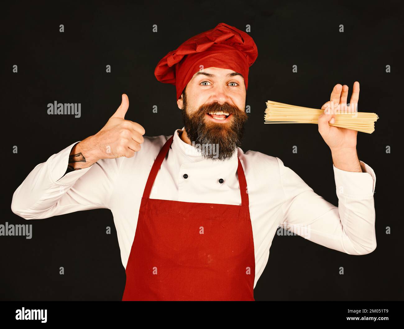 Chef with spaghetti shows thumbs up. Cooking italian food Stock Photo ...