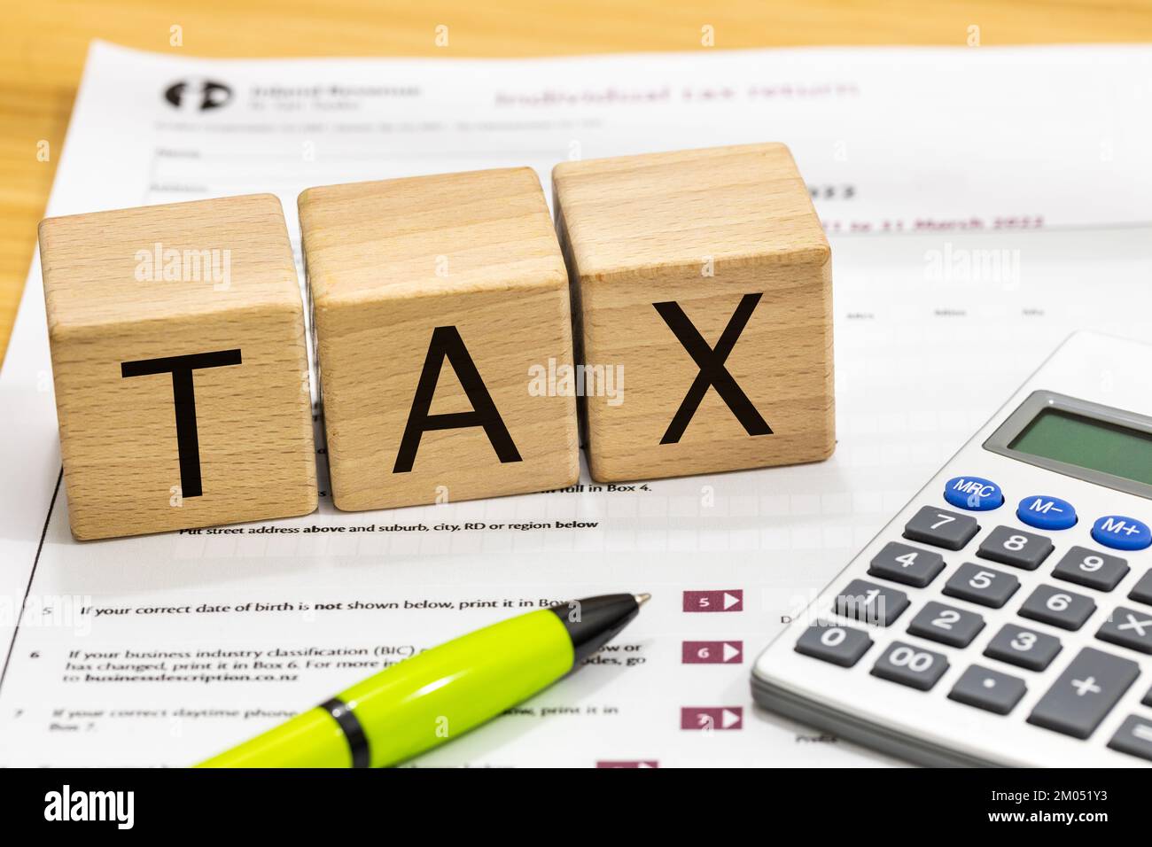 Individual New Zealand tax return, form IR3 and hand with pen of person ...