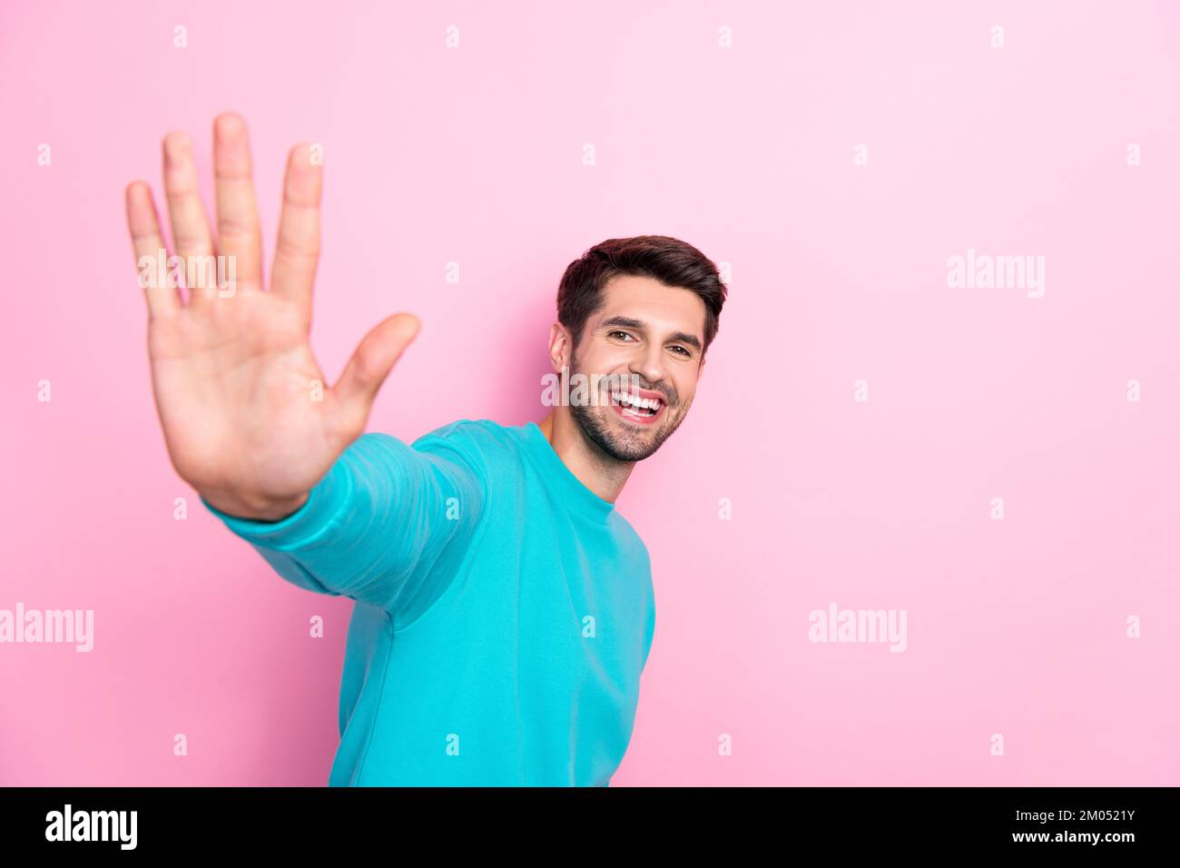 Photo portrait of handsome young man raise hand arm wave hello high ...