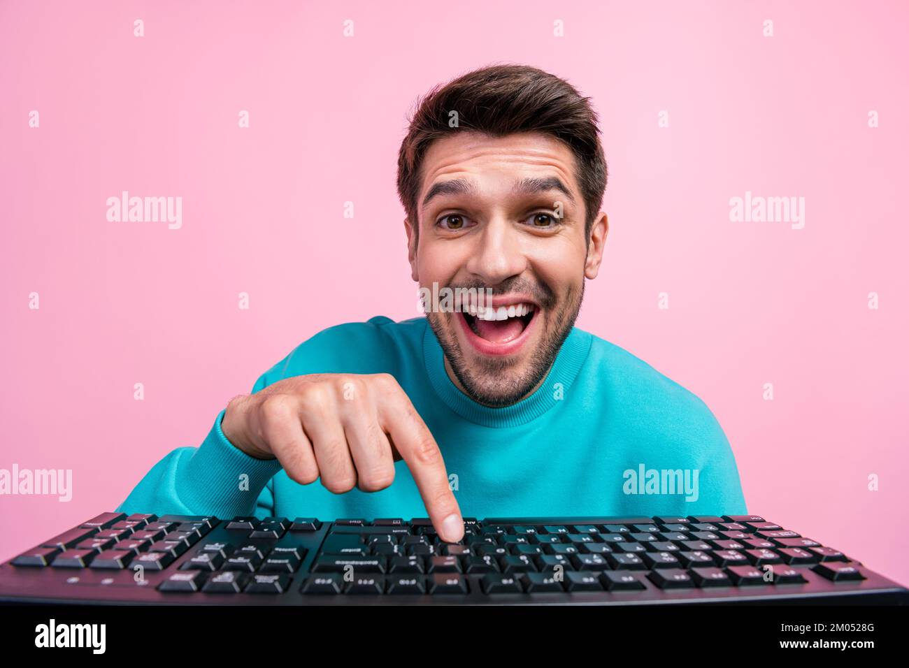 Photo portrait of handsome young man press key keyboard funny facial ...