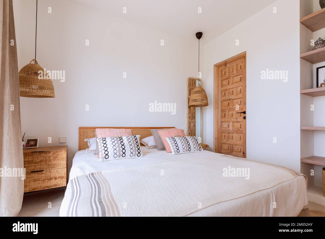 Mediterranean villa guest bedroom with wicker chandeliers, double bed ...