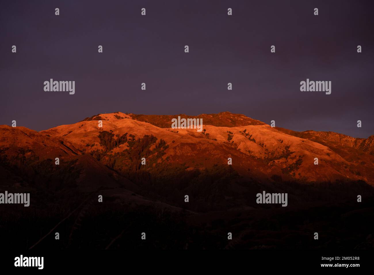 Bright Hill Side Highlighted Below Dark Purple Skies in Big Sur Stock ...