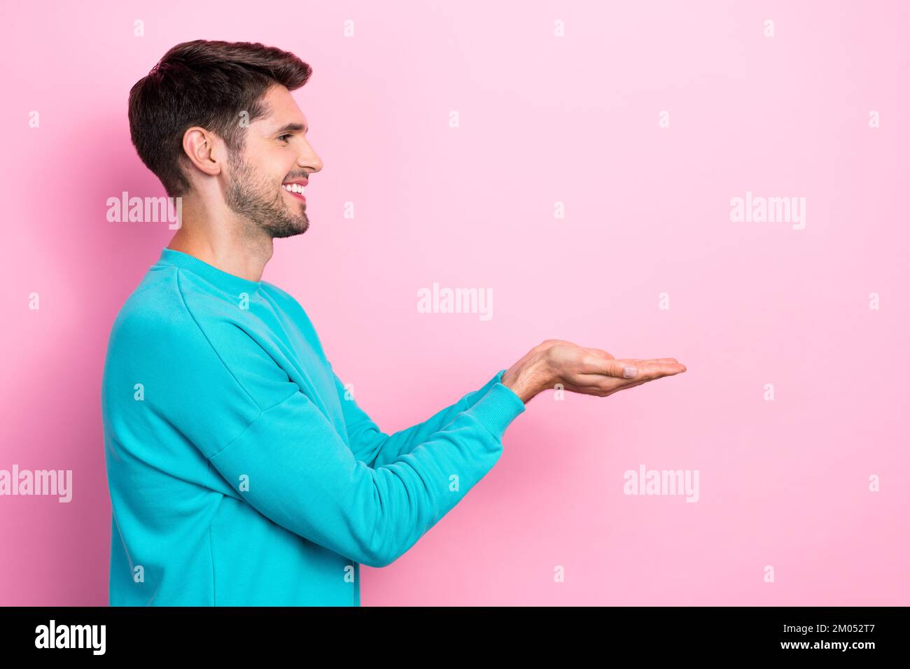 Photo portrait of handsome young man palms hold copyspace toothy smile ...