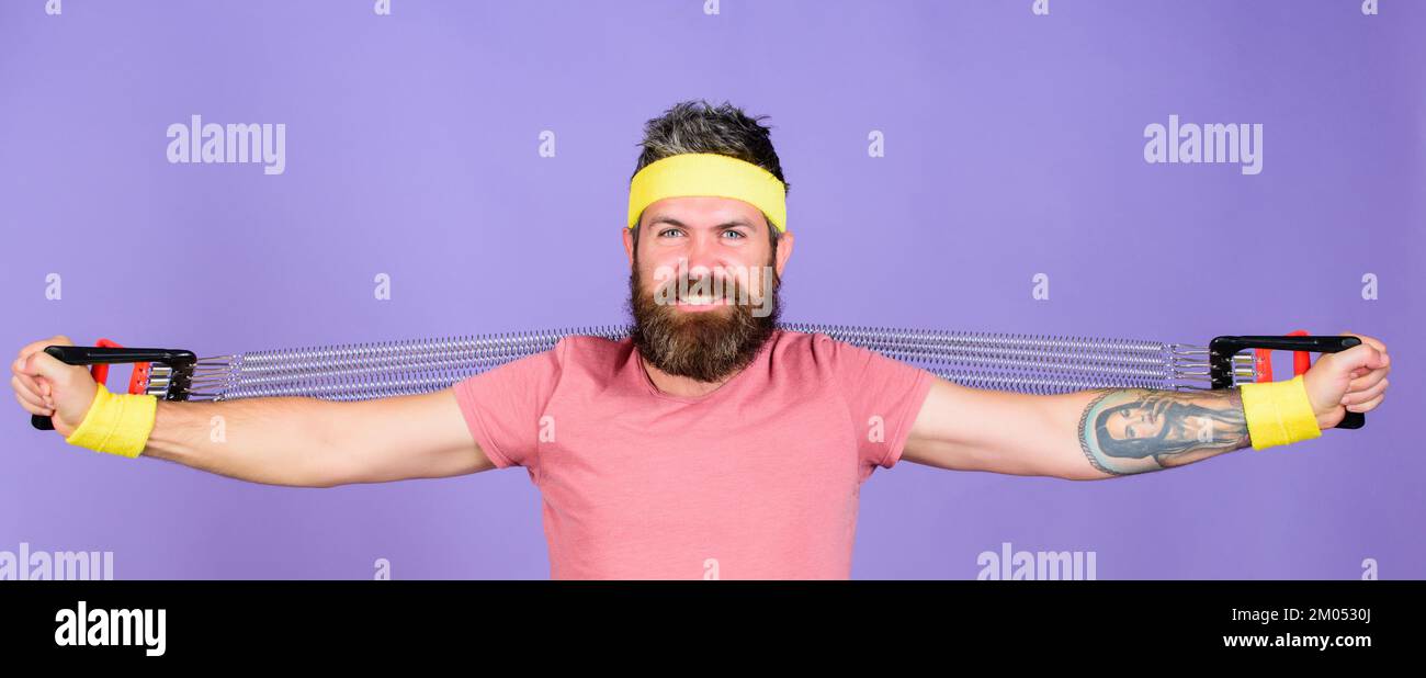 Man bearded athlete exercising with expander equipment. Athletics sport ...