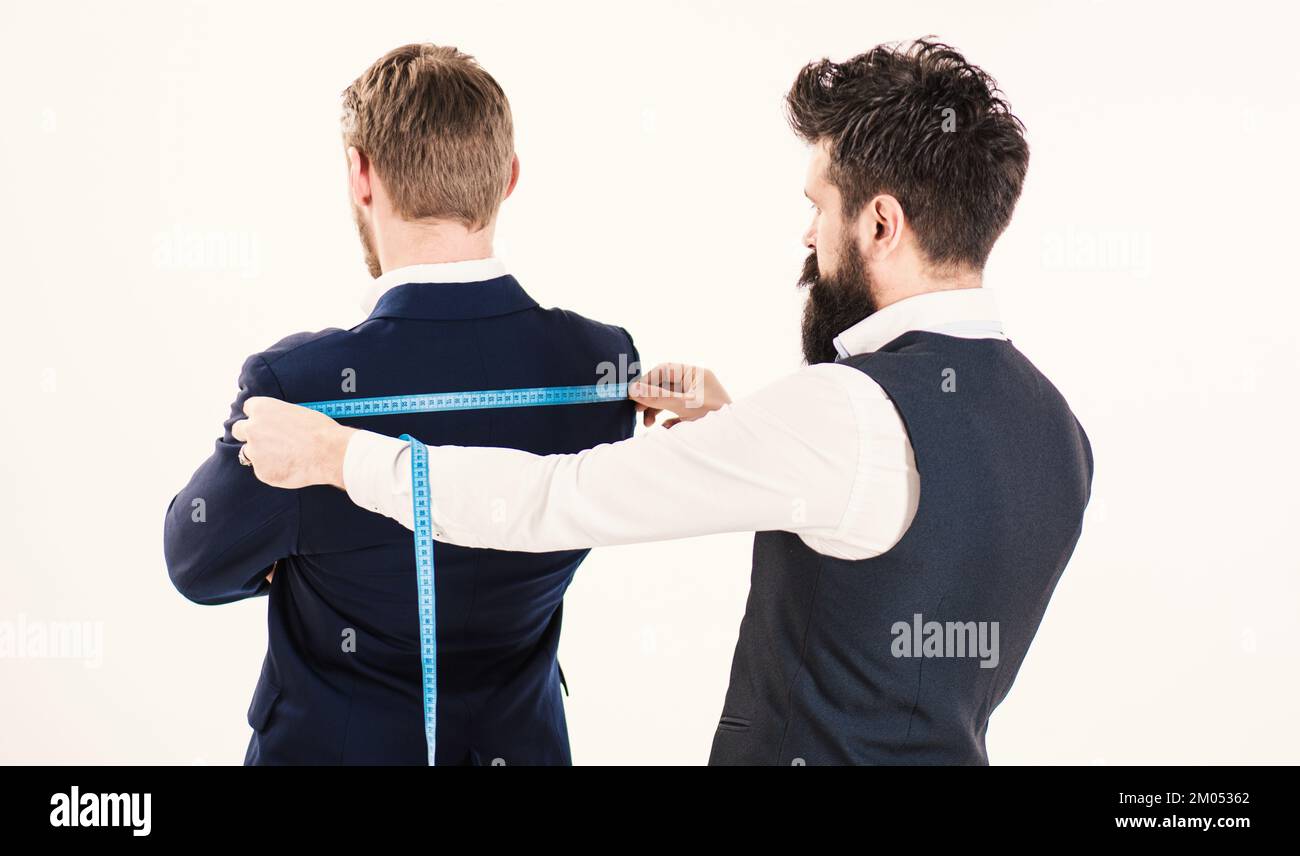 Businessman, client, customer visit tailor salon. Tailor measures back ...