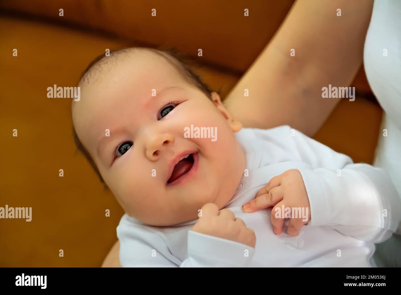 newborn baby smiles and laughs. shows emotions Stock Photo - Alamy