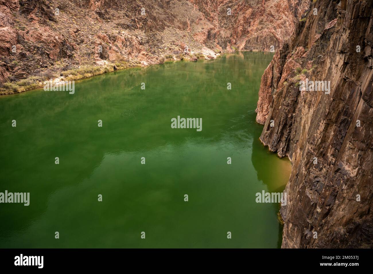 Calm Waters Of The Colorado River Turns The Corner Around A Tall Cliff ...