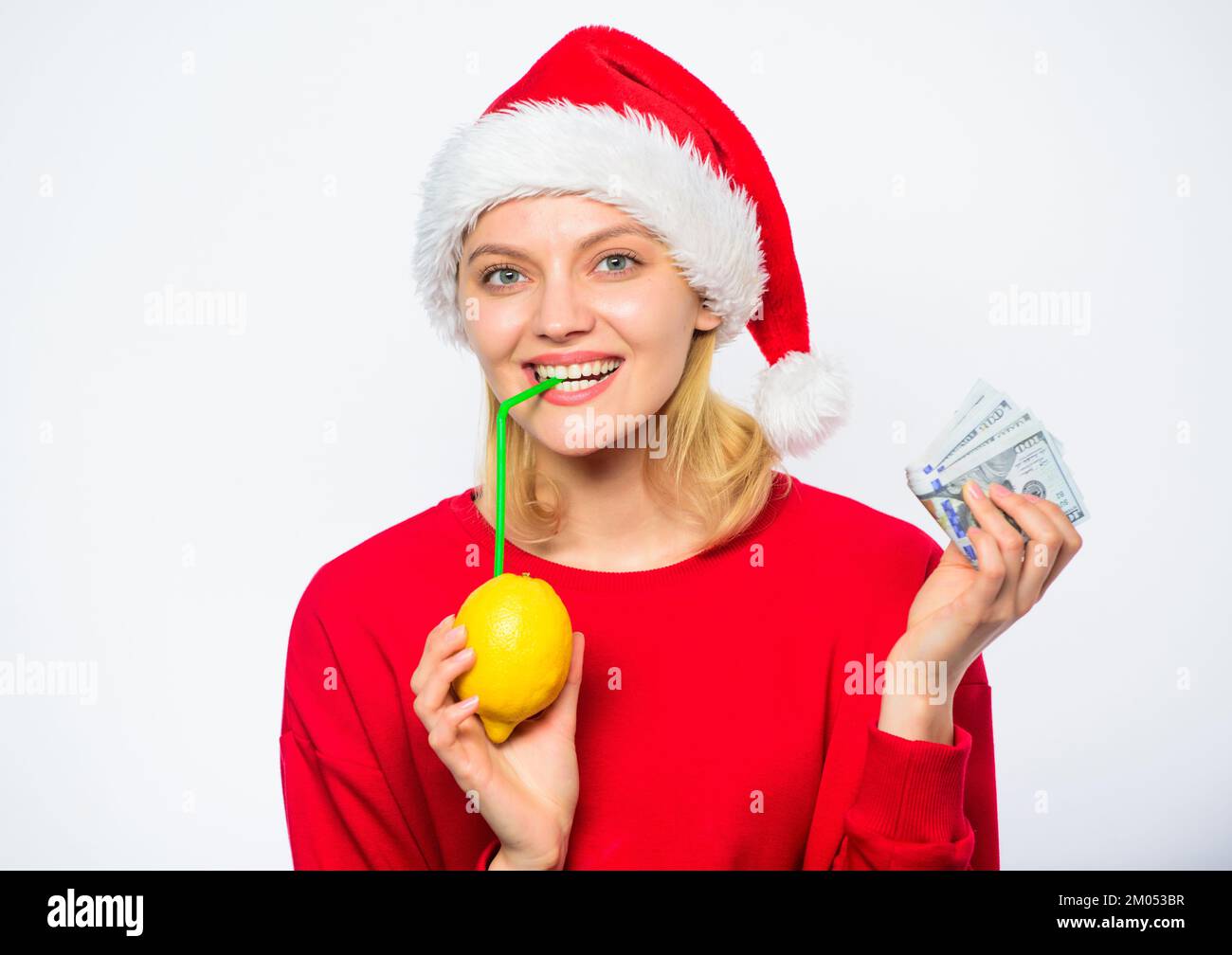 Christmas profit concept. Symbol of wealth and richness. Rich girl with lemon and money. Lemon ...