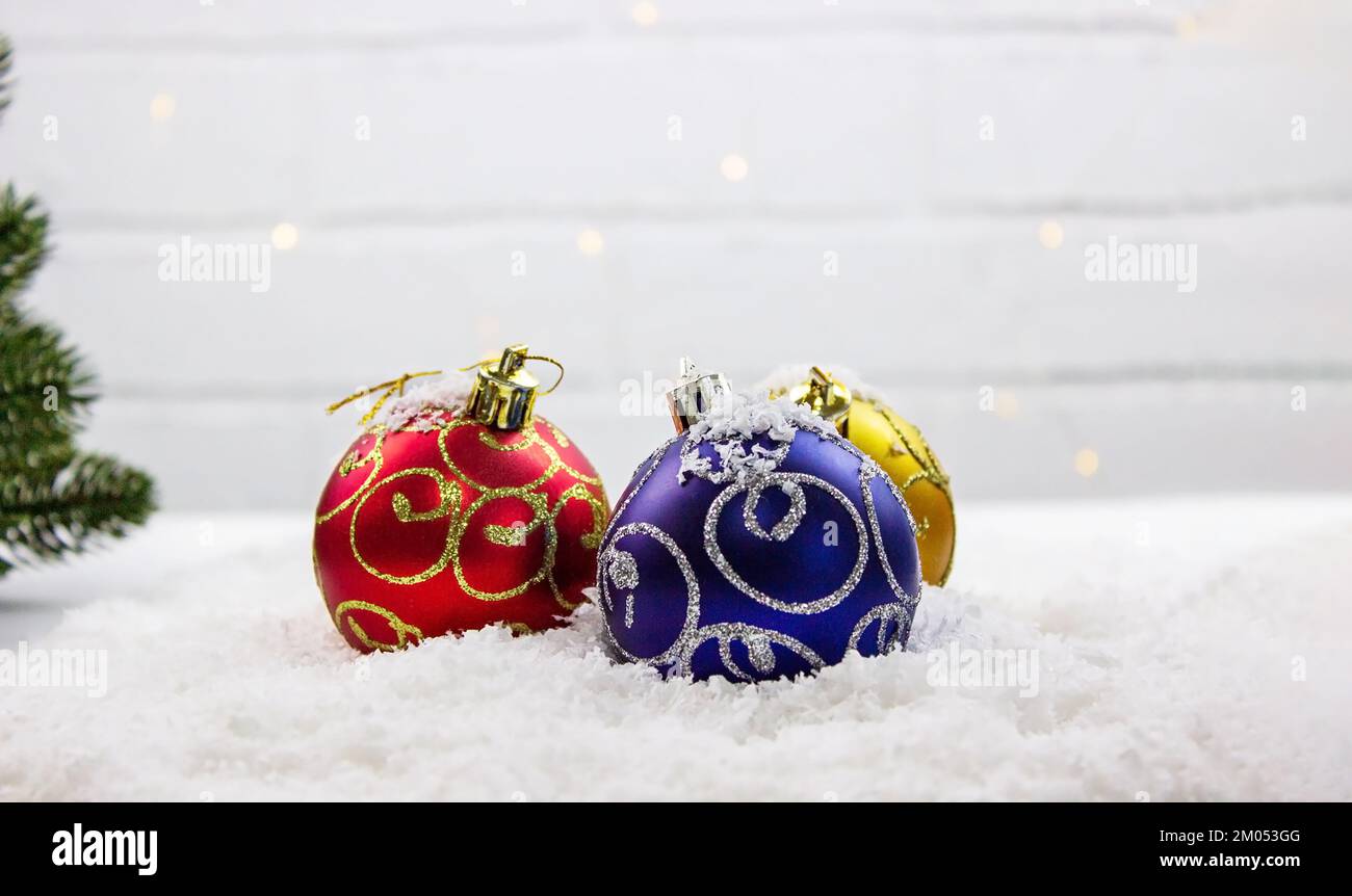 Christmas toys on a light background, in artificial snow. Selective ...