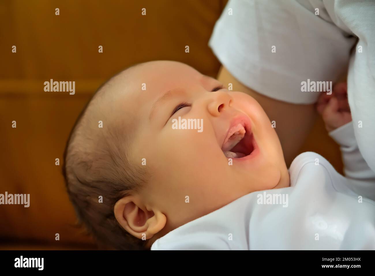 newborn baby smiles and laughs. shows emotions Stock Photo - Alamy