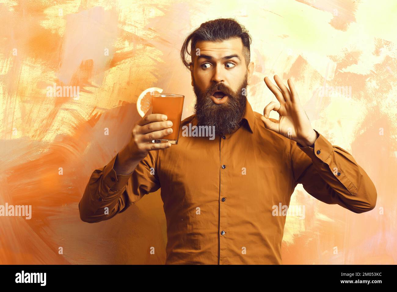 Brutal caucasian hipster holding tropical alcoholic fresh cocktail ...