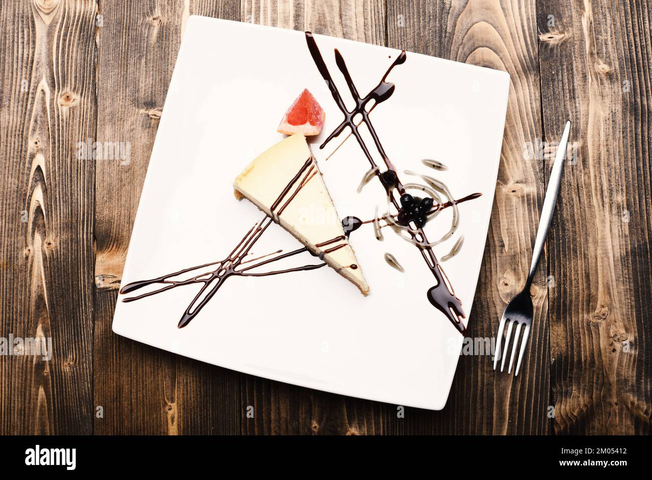 Dessert with chocolate lines, blueberries and grapefruit triangle decor ...