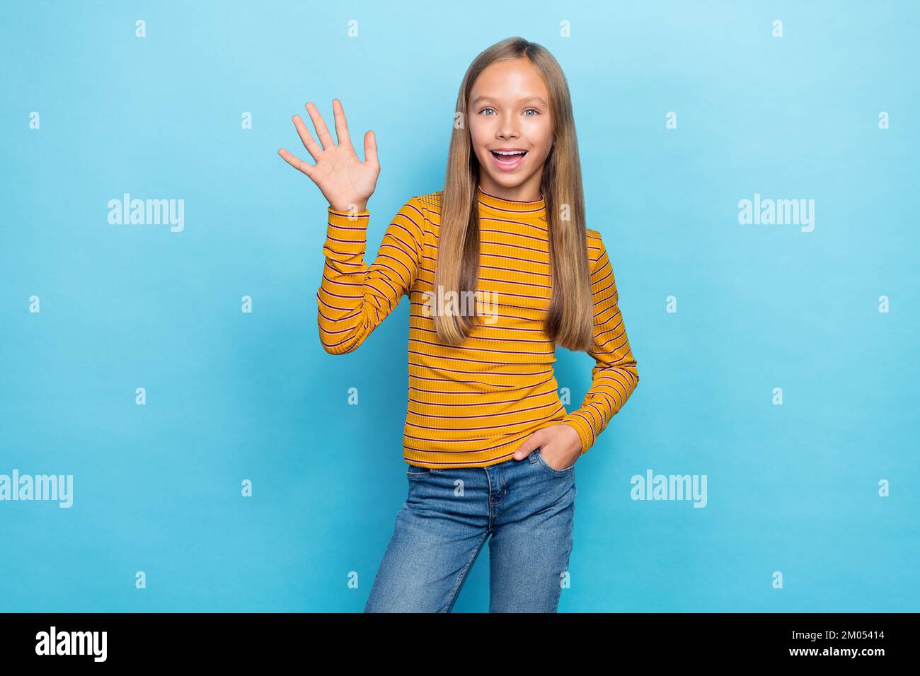 Portrait of satisfied lovely girl arm palm waving hi beaming smile ...