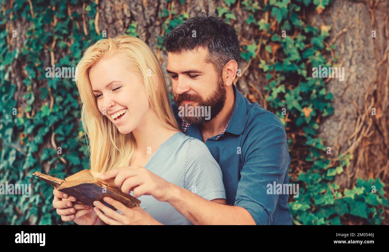 Romantic couple holds old book with poems about love Stock Photo - Alamy