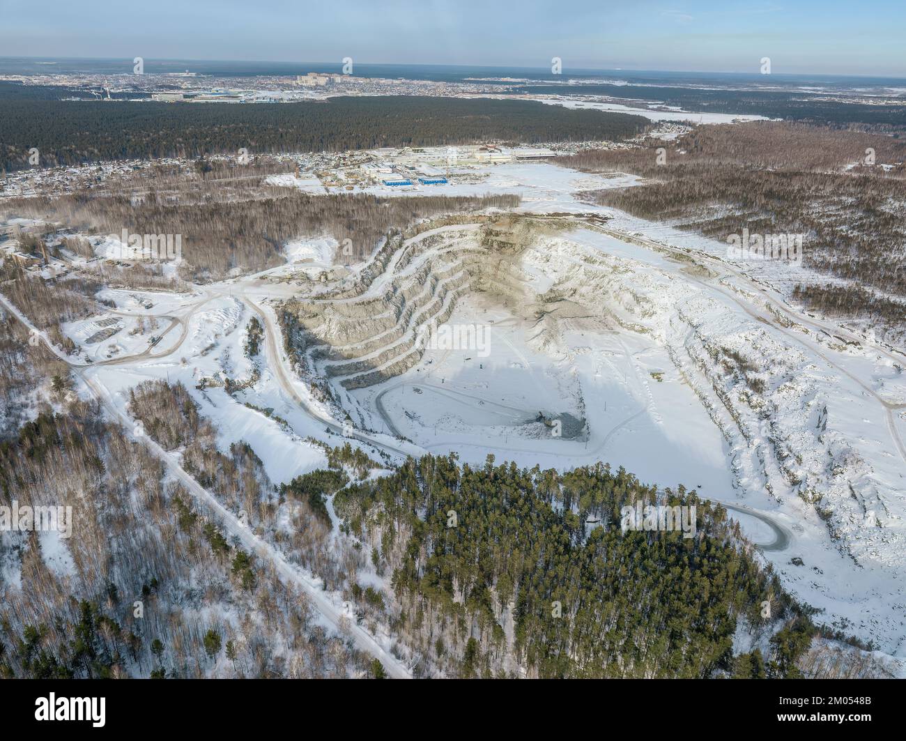 Aerial view to crushed stone quarry in winter with snow. Crushed stone ...