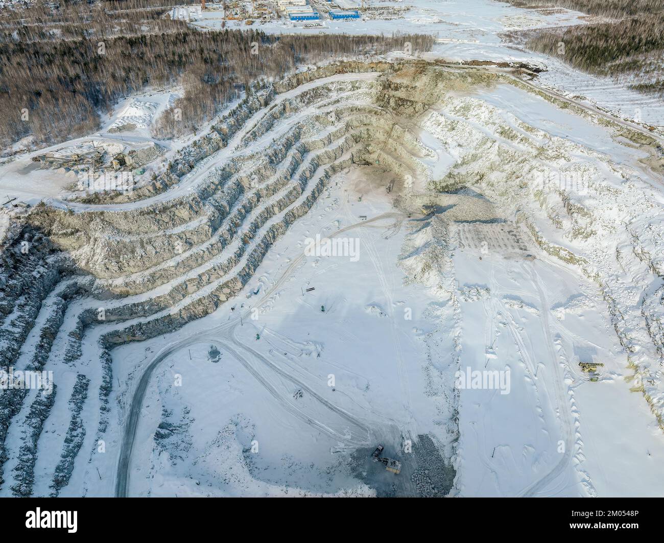 Aerial view to crushed stone quarry in winter with snow. Crushed stone ...
