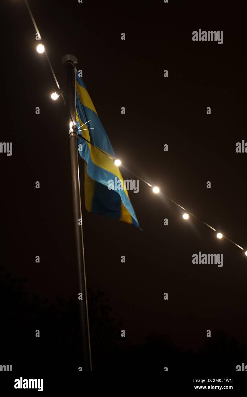 Blue and yellow striped flag with festival lights Stock Photo - Alamy