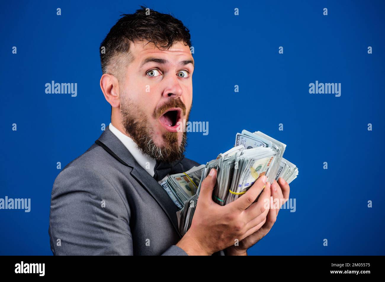 Cash transaction business. Man happy winner rich hold pile of dollar ...