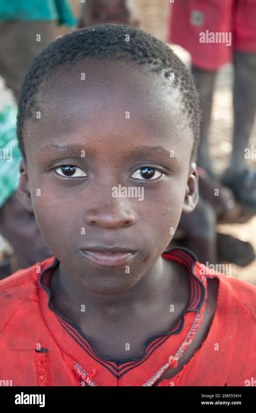 Faces of Africa, young boy, Bafata, Guinea Bissau; Young boy with ...