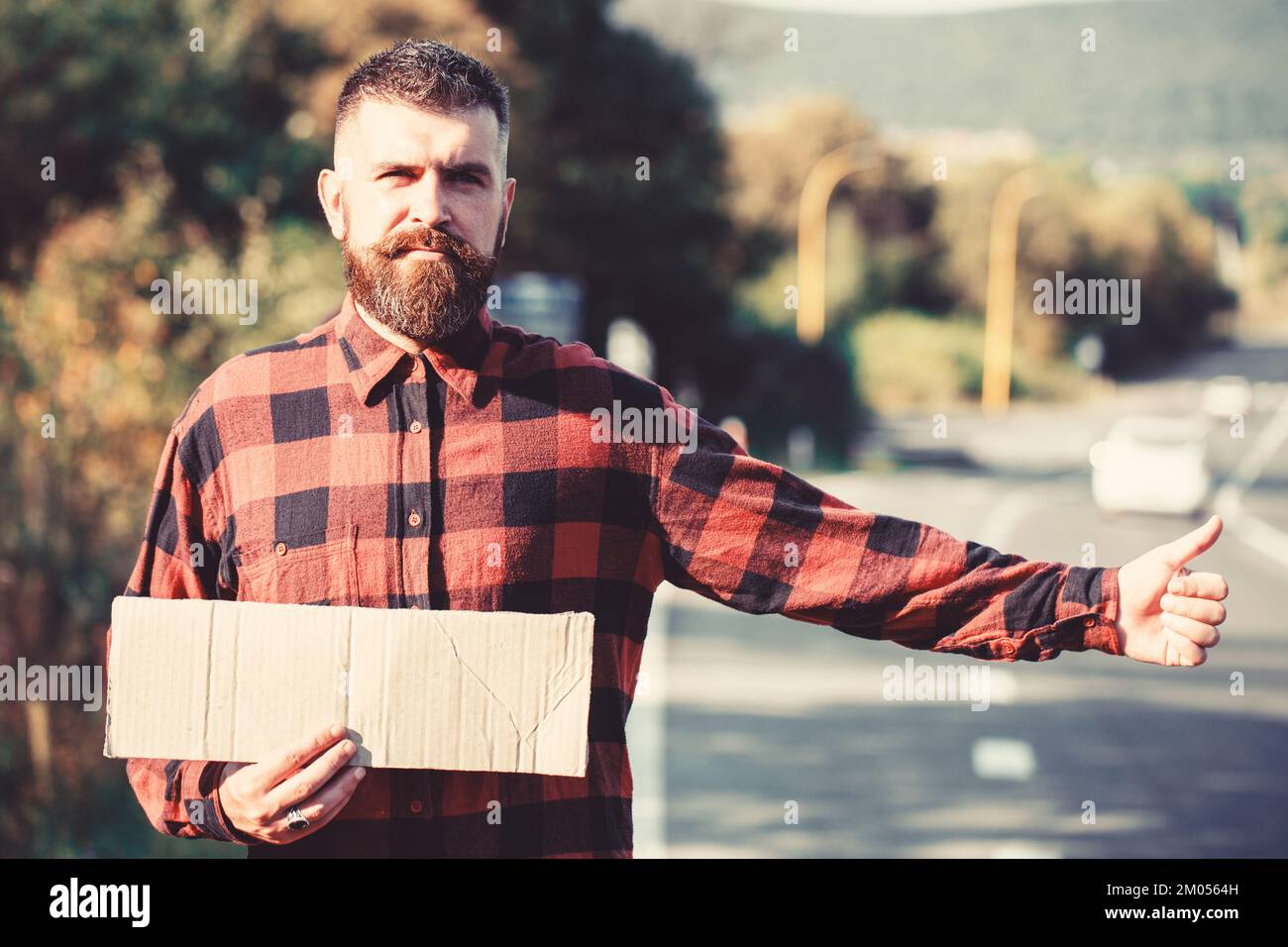 Man with strict face and beard travelling by hitchhiking Stock Photo ...