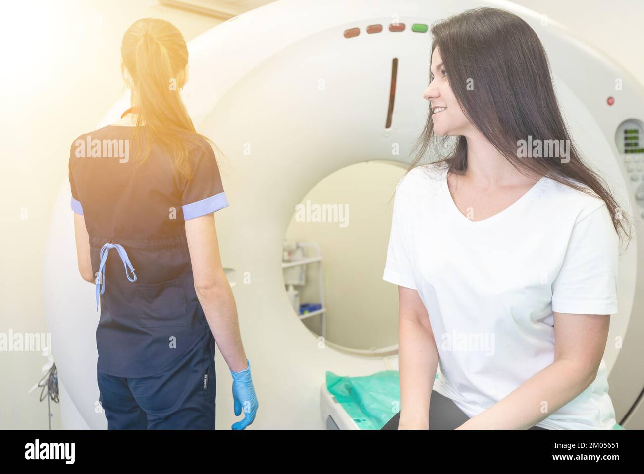 Pretty, young woman goiing through a Computerized Axial Tomography CAT ...