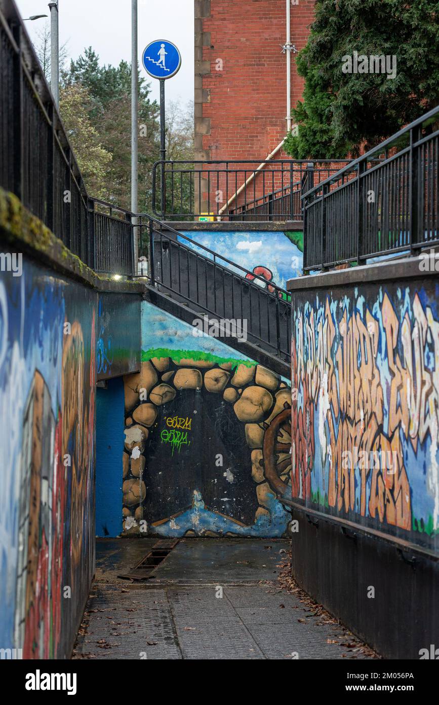 Creepy subway, dark and dingy with graffiti on the walls. Blue walls ...