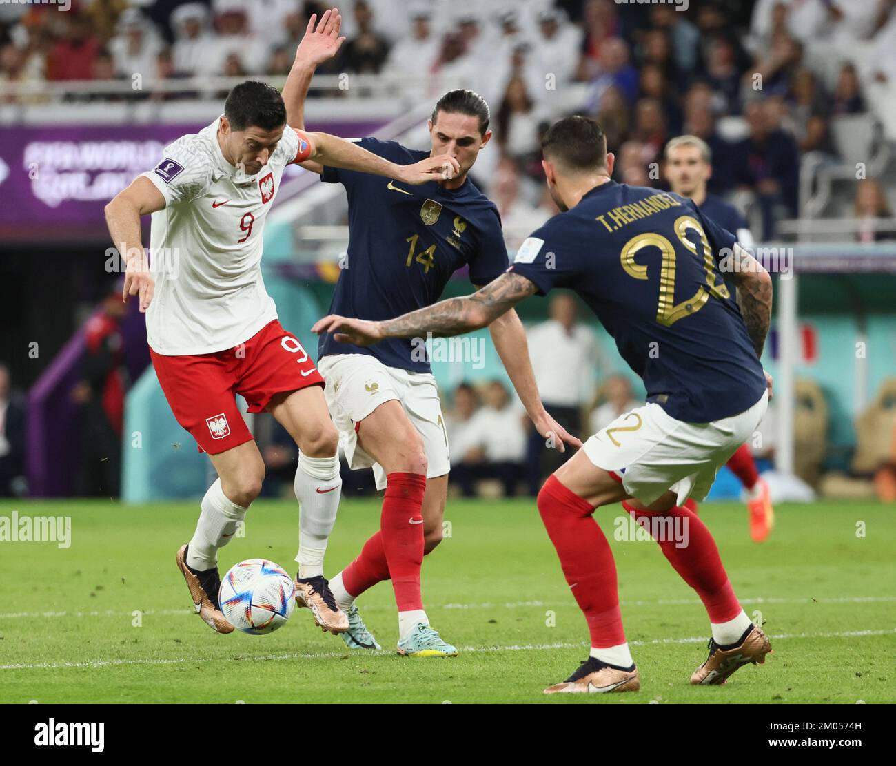 Doha, Qatar. 4th Dec, 2022. Robert Lewandowski (1st L) of Poland vies ...