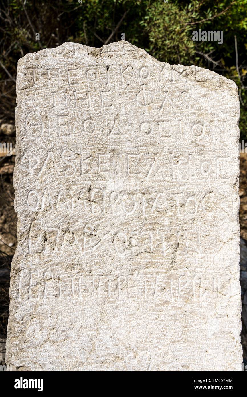 Antique greek inscriptions carved on the stone of the old ruins of an ...