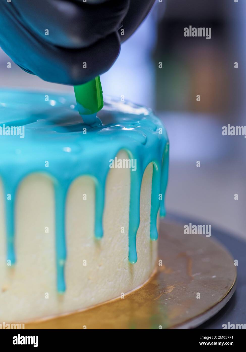 bag piping filling topping on frosted icing drip turquoise cake for ...