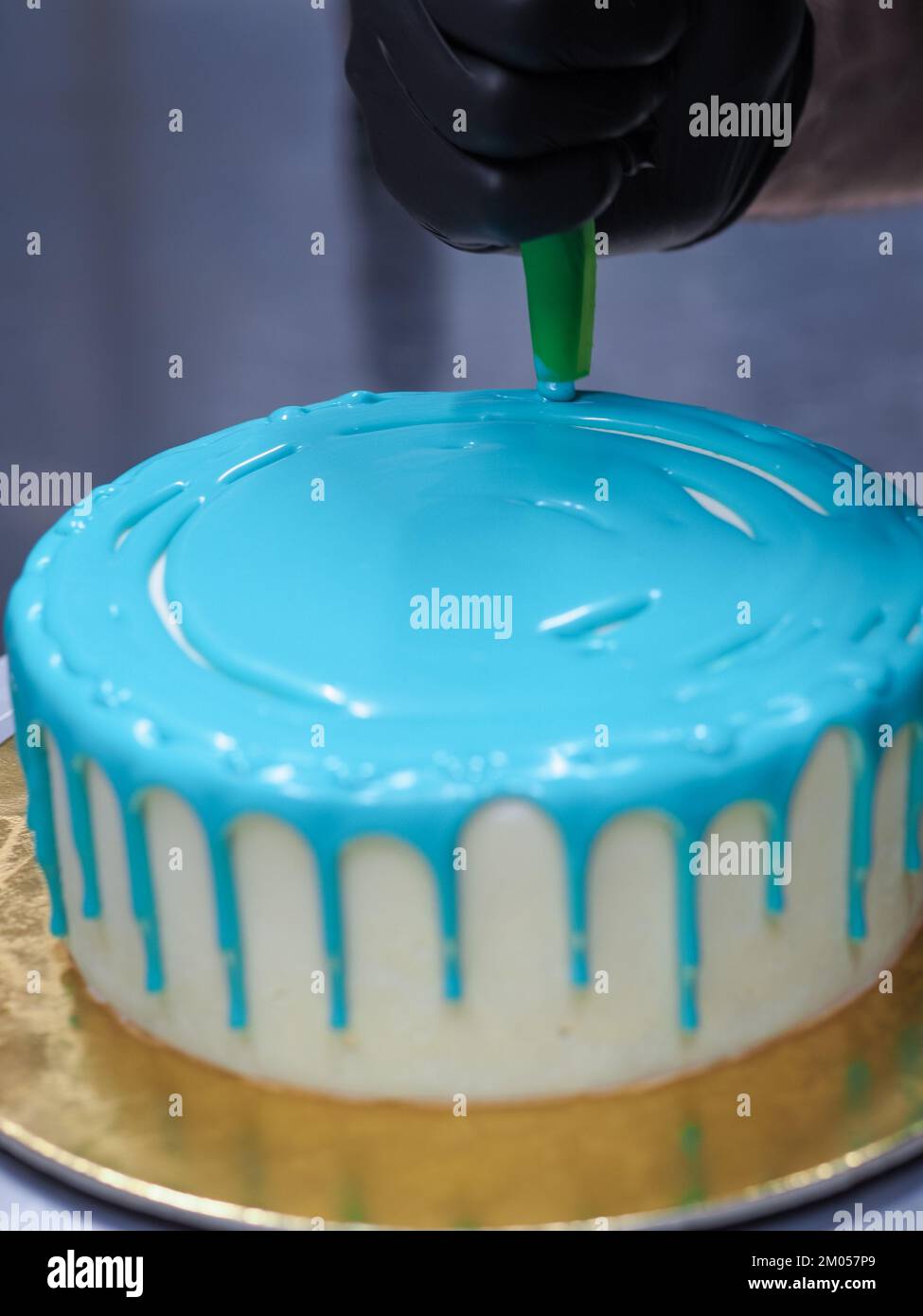 bag piping filling topping on frosted icing drip turquoise cake for ...