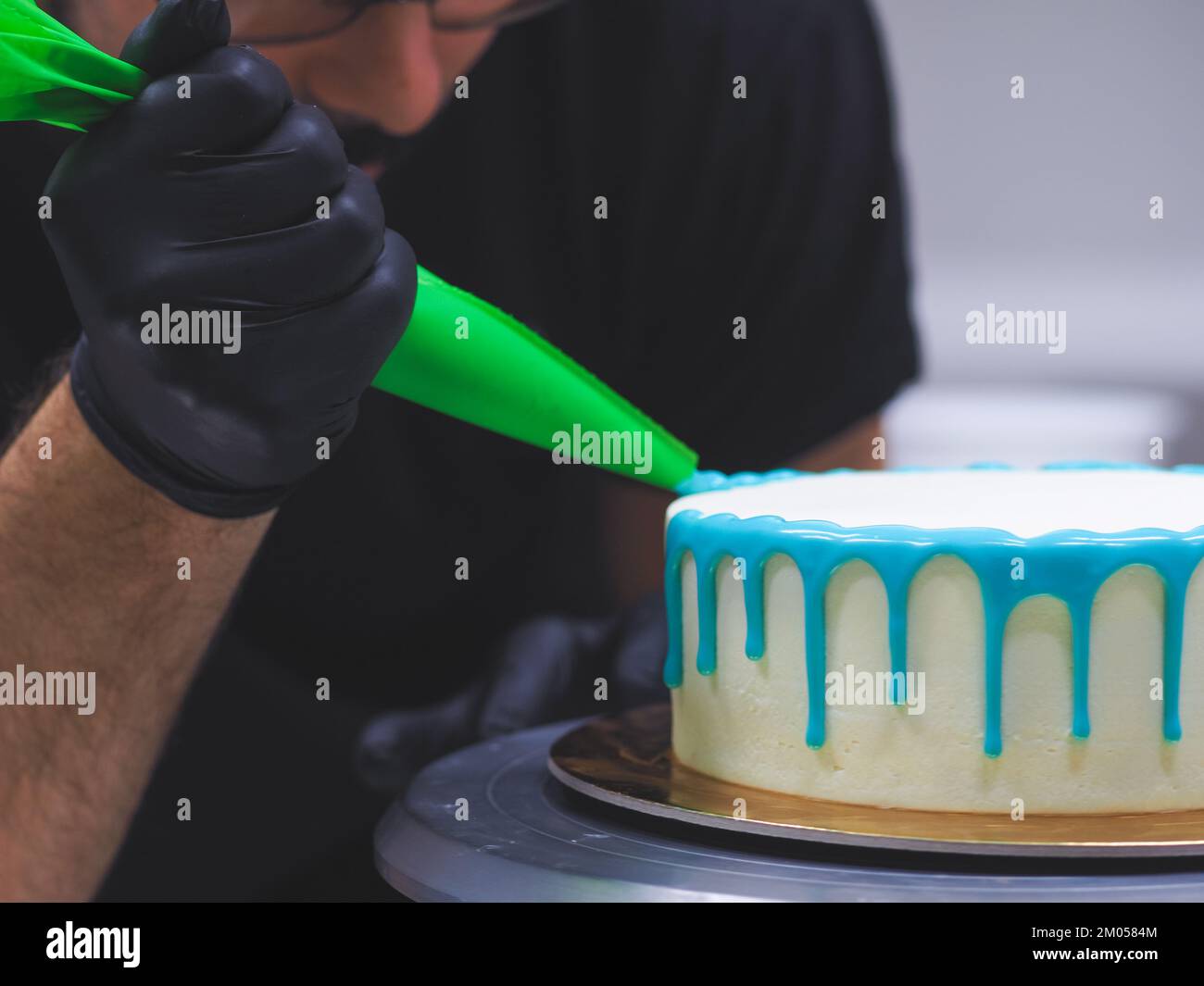 bag piping filling topping on frosted icing drip turquoise cake for ...