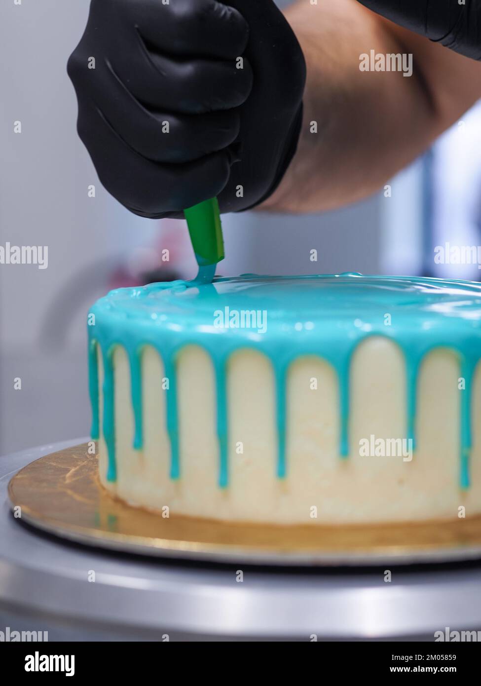 bag piping filling topping on frosted icing drip turquoise cake for ...