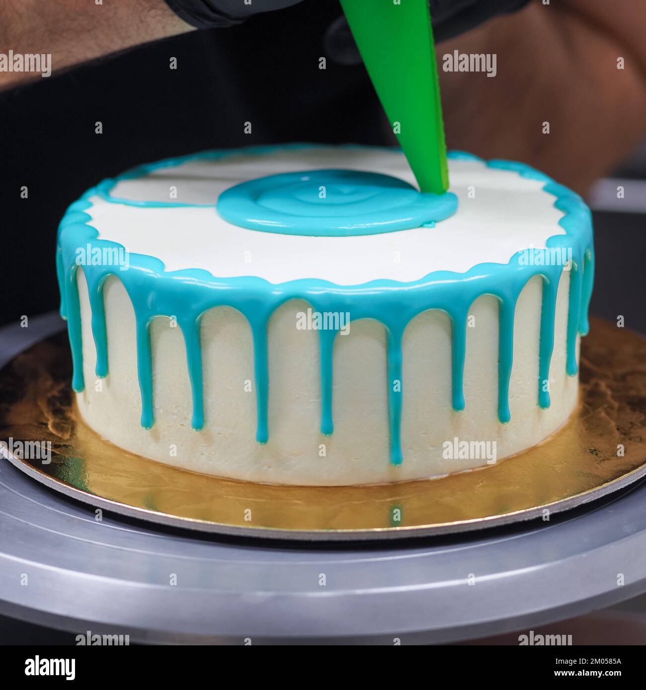bag piping filling topping on frosted icing drip turquoise cake for ...