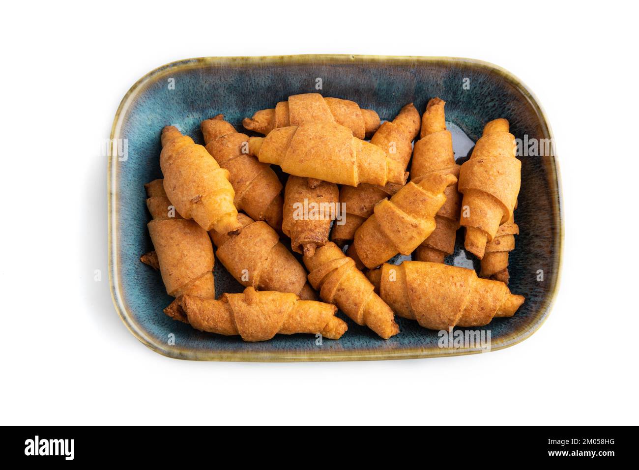 Homemade bagel roll on blue ceramic plate isolated on white background ...